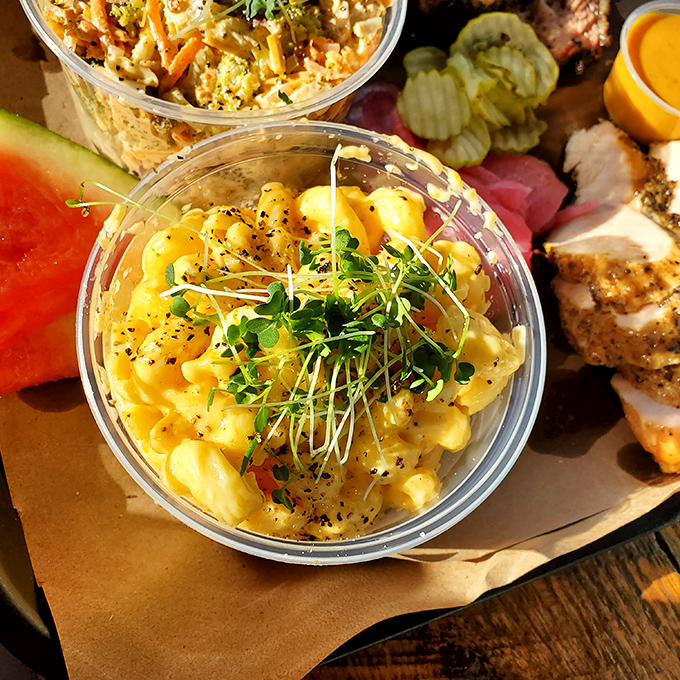 Mac and cheese elevated to art form, crowned with fresh microgreens because someone thought, "Hey, let's make this technically count as a salad."