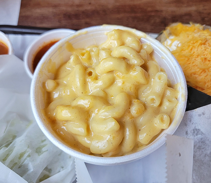 Mac and cheese that doesn't try to reinvent itself with truffle oil or lobster. Just creamy, cheesy comfort that knows its supporting role in the meat symphony.