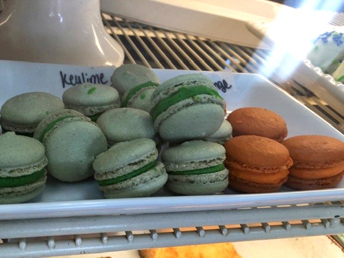 Mint and orange macarons lined up like colorful soldiers, ready to wage delicious war on your willpower.
