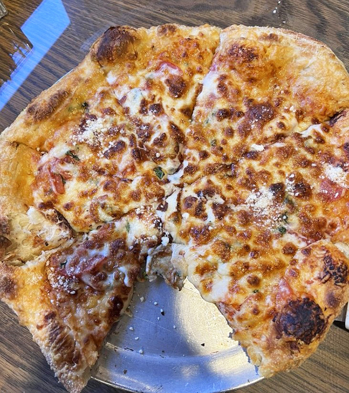 This hand-tossed pizza has the perfect cheese-to-crust ratio&mdash;the kind that makes you wonder if the chef has a Ph.D. in geometry.