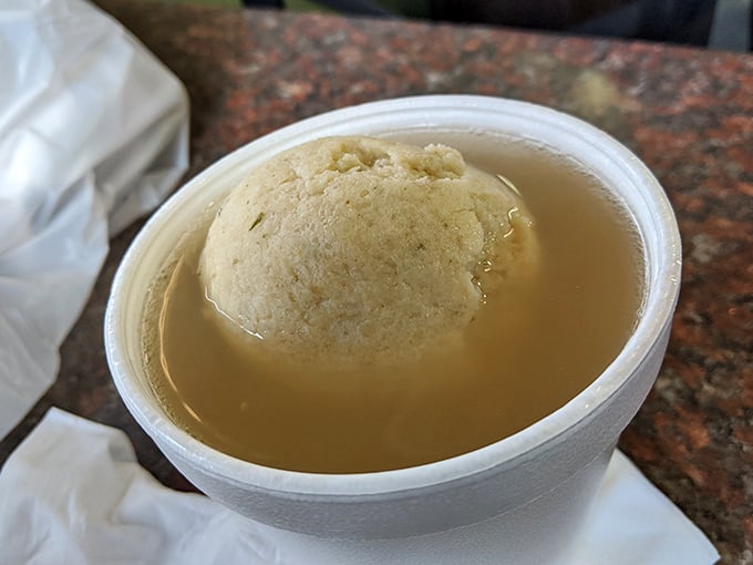 A matzo ball floating in golden broth like the moon in a chicken-flavored sky. Grandmothers everywhere would approve of this healing potion.