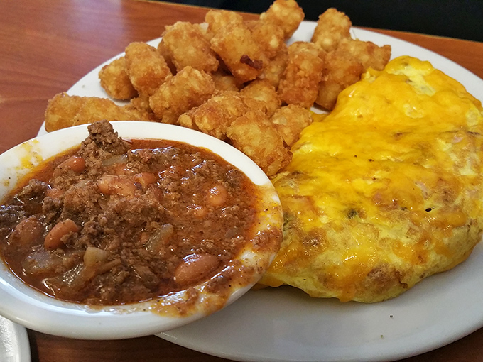 This isn't just breakfast, it's architecture &ndash; golden tater tots, hearty chili, and an omelet that practically glows with cheesy promise.