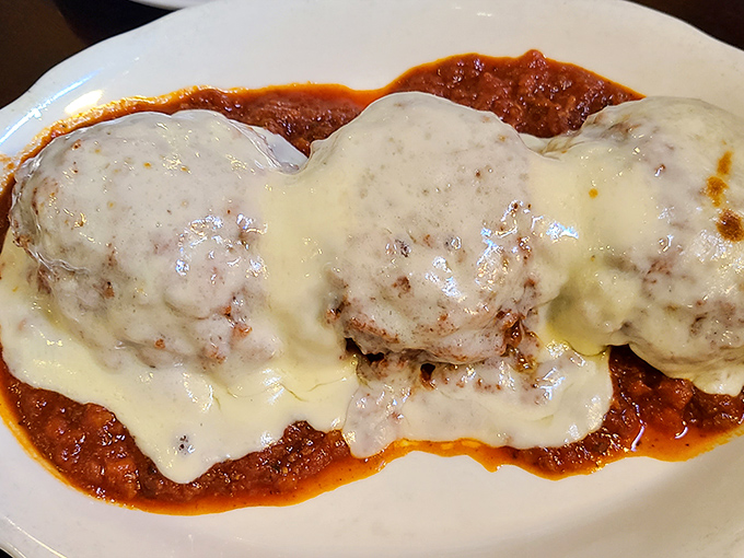 These meatballs aren't just swimming in marinara&mdash;they're doing the backstroke in a pool of molten cheese that stretches with Olympic-worthy determination.
