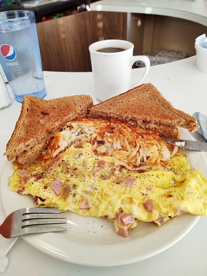 This ham and cheese omelet isn't just breakfast &ndash; it's a fluffy yellow canvas painted with melted cheese and studded with savory ham jewels.