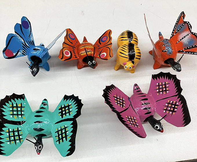 These vibrant hand-painted butterflies and critters bring folk art charm to any shelf, like tiny ambassadors from a more colorful dimension.