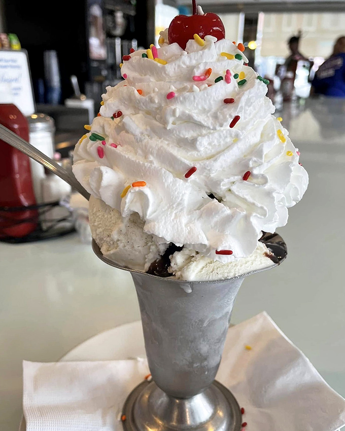 Dessert or work of art? This towering sundae with its crown of whipped cream and cherry throne proves that some childhood joys only get better with age.
