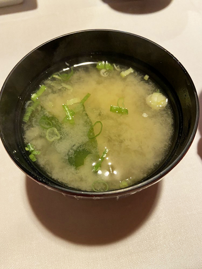 A bowl of miso soup that transcends its humble ingredients&mdash;delicate broth, dancing scallions, and the comforting warmth that signals the start of something wonderful.