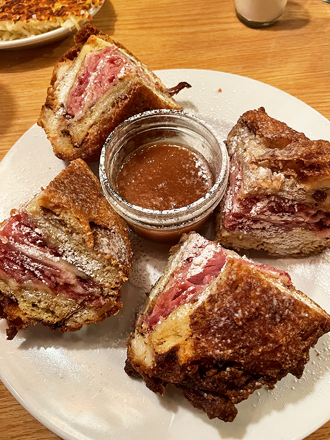 The Monte Cristo: where French toast meets ham and cheese in a powdered sugar snowstorm that would make even Elvis say "thank you, thank you very much."