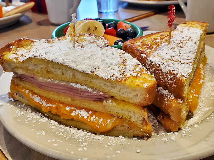 The Monte Cristo: French toast's sophisticated cousin who went to culinary school and came back with powdered sugar epaulets and a ham-and-cheese heart.