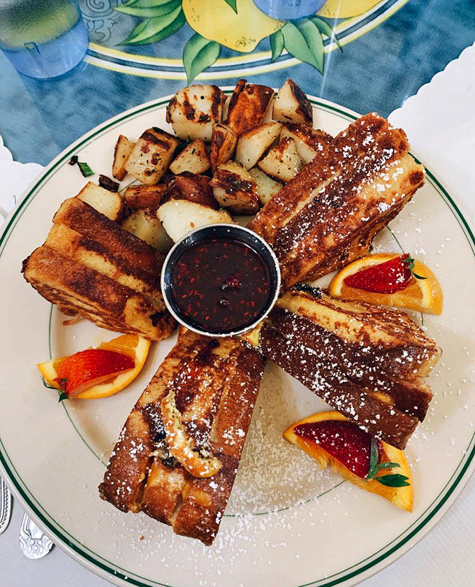 French toast arranged like sun rays around a pool of maple syrup&mdash;architectural breakfast brilliance that tastes even better than it looks.