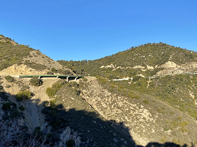 Engineering marvel meets natural wonder as the highway gracefully arcs through these rugged mountain passes.