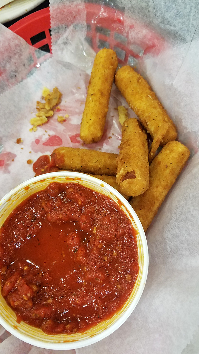 Golden mozzarella sticks with that perfect pull-apart stretch, paired with chunky marinara that could make a cardboard box taste gourmet.