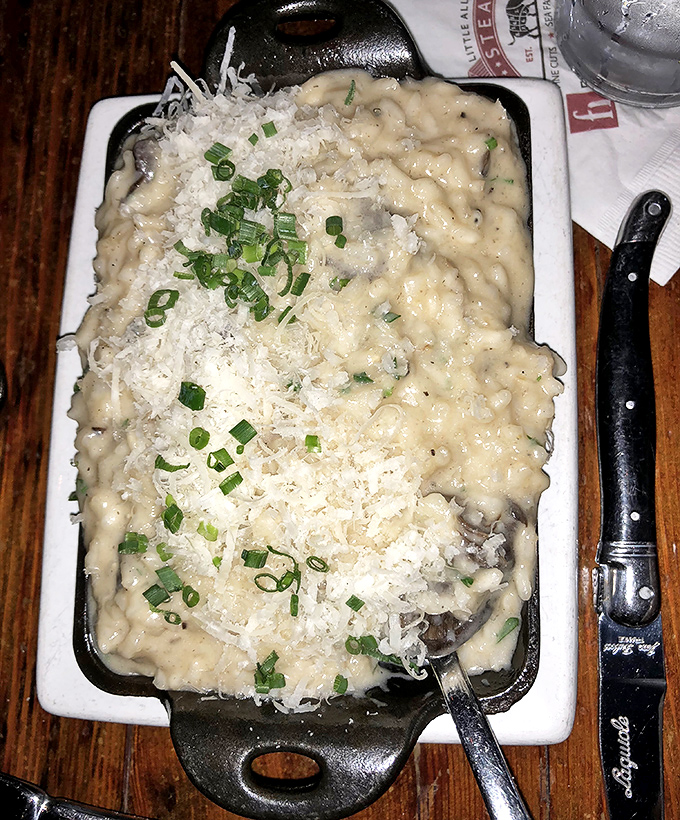 Risotto that achieves the impossible: creamy yet perfectly al dente. Topped with fresh herbs and parmesan, it's the supporting actor that threatens to steal the show.
