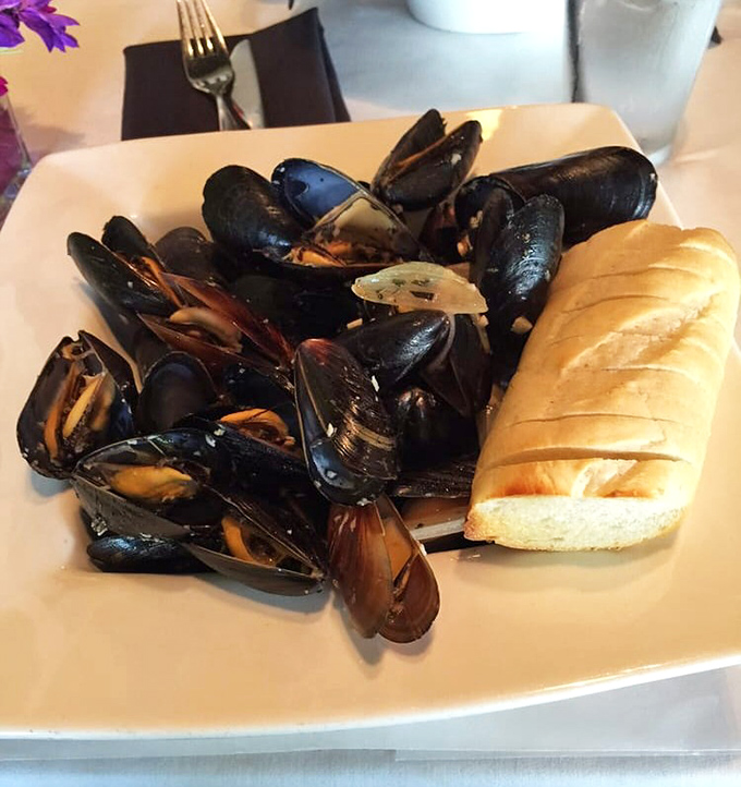 These glistening mussels aren't just dinner; they're a maritime celebration served with crusty bread for essential broth-sopping duties.