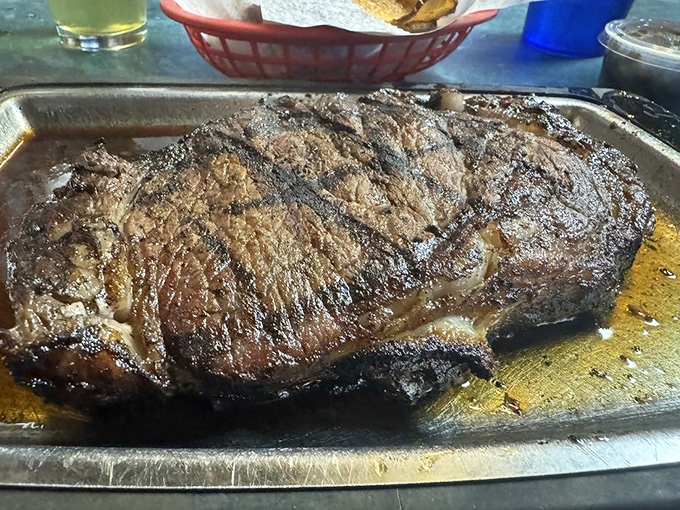 This New York strip steak isn't just dinner&mdash;it's performance art. The juices pooling on that metal tray are basically flavor autographs from meat celebrity.
