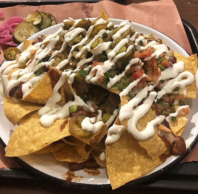 These aren't your college dorm room nachos. Lewis elevates the humble chip to an art form with brisket bits and drizzles of creamy salvation.