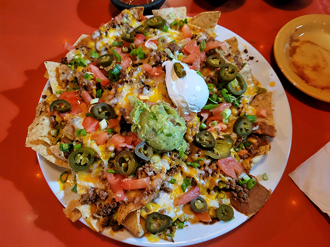 These nachos aren't just loaded, they're having an existential crisis under the weight of all those jalape&ntilde;os, cheese, and guacamole. Worth every crunchy bite.