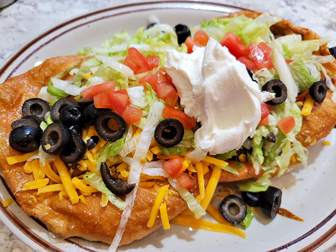 The Navajo Taco isn't just a meal, it's an edible topographical map of flavor country, with peaks of sour cream and valleys of savory goodness.
