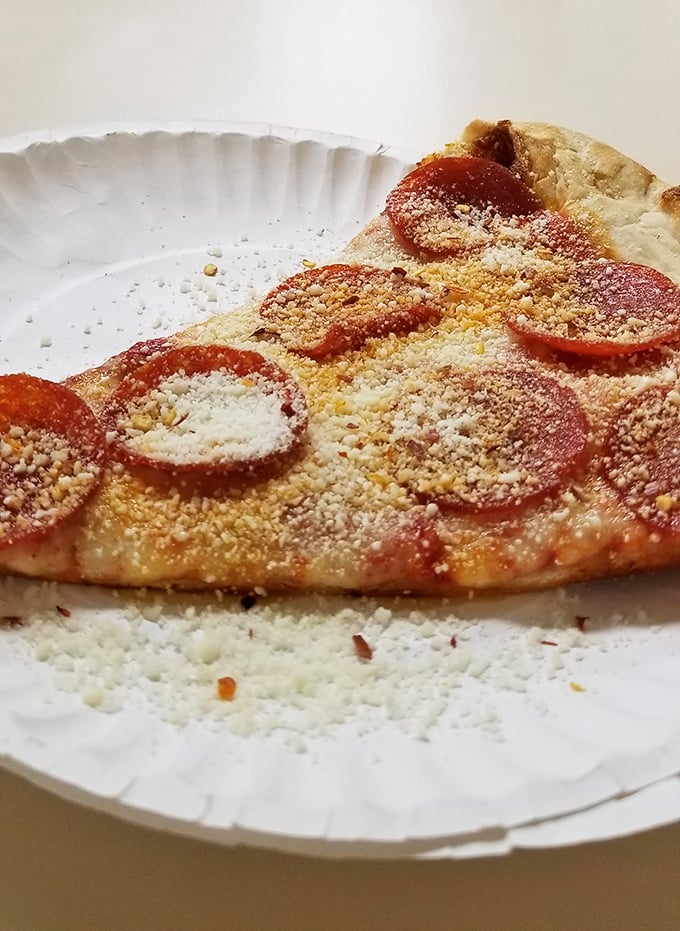 That dusting of Parmesan on pepperoni isn't just garnish&mdash;it's the final blessing in a sacred pizza ritual.