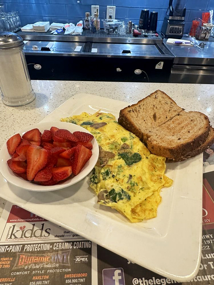 This isn't just an omelet&mdash;it's a morning masterpiece with fresh strawberries playing the perfect supporting role. Breakfast of champions, indeed.