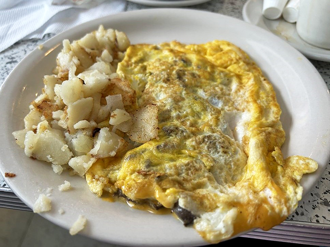 This isn't just an omelet&mdash;it's a fluffy yellow blanket of eggs keeping those perfectly seasoned home fries warm and cozy.