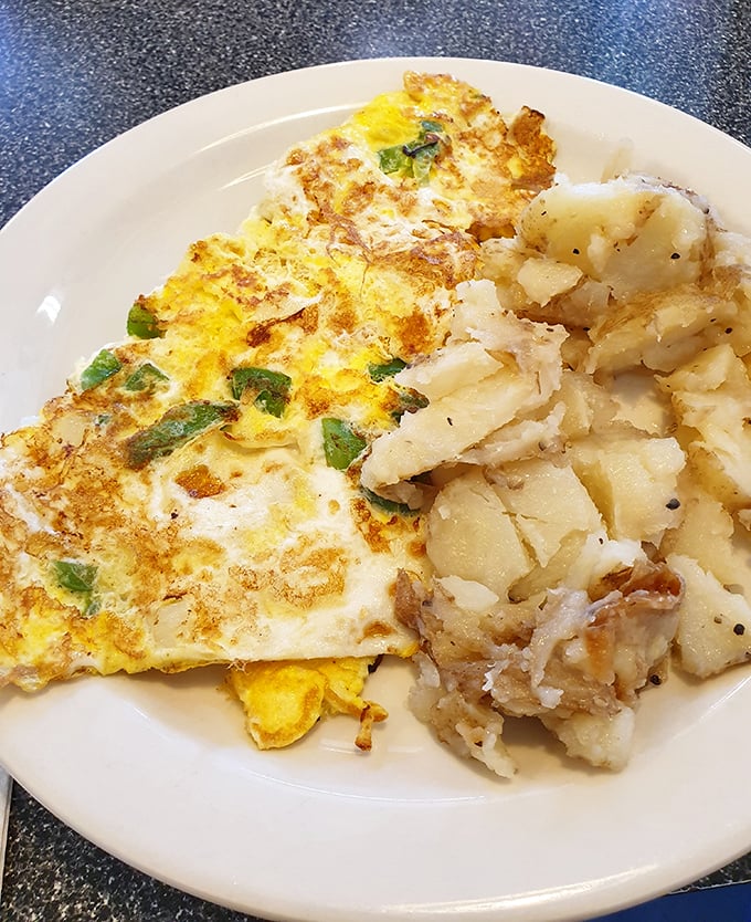 An omelet that actually tastes like eggs, not air, paired with home fries that could make a potato farmer weep with pride.