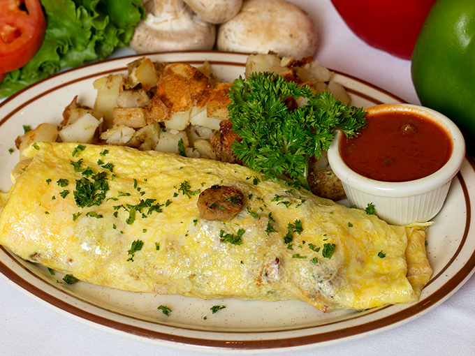 This isn't just an omelet; it's architecture &ndash; a perfectly folded egg exterior housing a treasure trove of fillings, with crispy hash browns standing guard.
