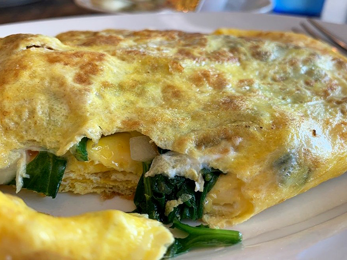 An omelet so perfectly executed it should have its own Instagram account. Those spinach-filled folds are the breakfast equivalent of finding extra money in your pocket.