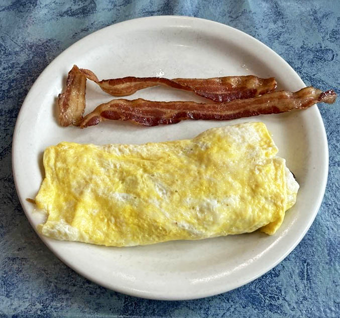 The omelet and bacon plate&mdash;proof that simplicity executed perfectly is the highest form of culinary art. Breakfast doesn't need to be complicated to be extraordinary.