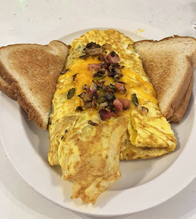 This isn't just an omelet; it's a perfectly executed envelope of egg delivering a love letter of ham, cheese and veggies to your taste buds.