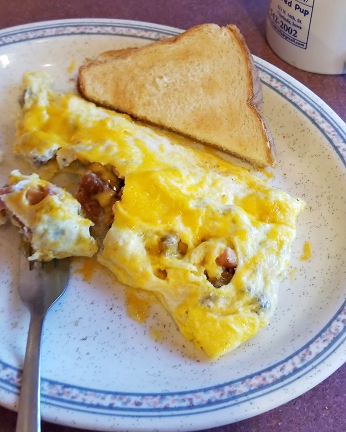 Golden omelets stuffed with bacon bits prove that breakfast can be pure art on a plate.