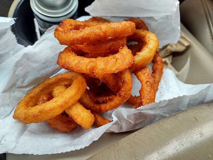 These onion rings aren't just fried—they're transformed into golden halos of crispiness that crackle with each bite like nature's perfect snack.