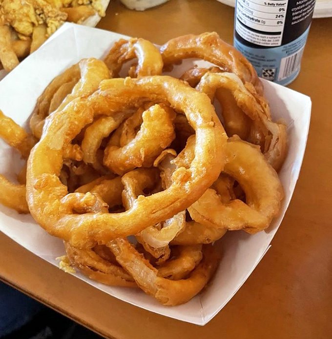 These golden onion rings have the kind of thick-cut crunch that makes you forget vegetables were ever considered virtuous or boring.
