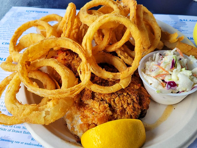 These onion rings aren't just side dishes, they're golden halos crowning perfectly fried seafood. The coleslaw provides a cool, creamy counterpoint to all that glorious crunch.