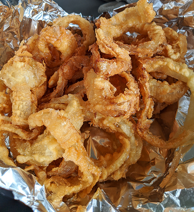 Onion rings that make you question every other onion ring you've ever eaten. Golden, crispy armor protecting sweet, tender onion—the knight and damsel of fast food.