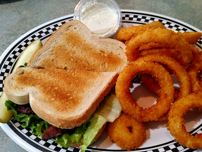 Golden, crispy onion rings that shatter with each bite, paired with a perfectly toasted sandwich. Some combinations are simply meant to be.