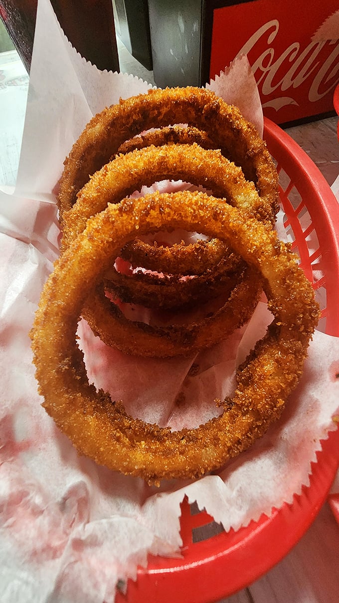Golden onion rings stacked like edible architecture, proving that sometimes the simplest pleasures are the most profound.
