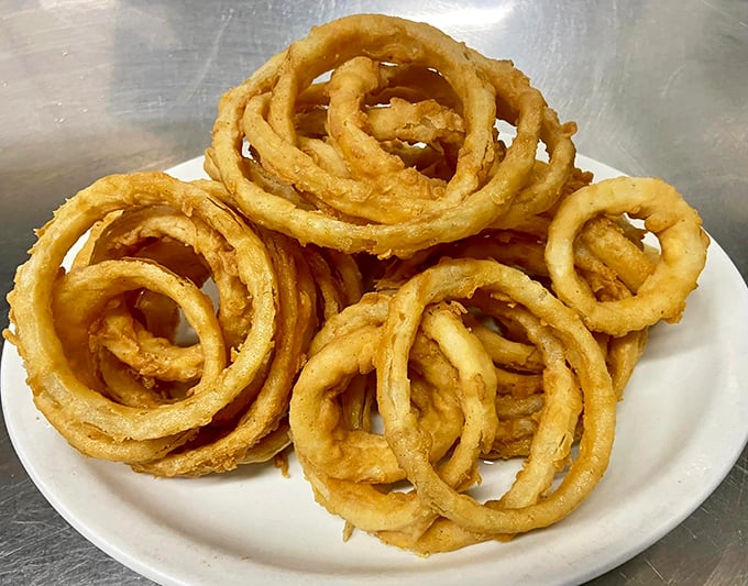 Onion rings stacked like golden halos&mdash;crispy, light, and the perfect excuse to say "just one more" at least six times.