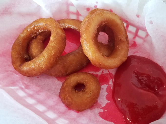 These onion rings aren't just side dishes—they're crispy golden halos that deserve their own fan club and possibly a small shrine in the Comfort Food Hall of Fame.