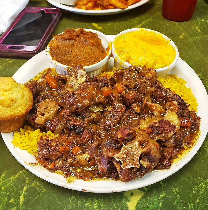 Oxtails so tender they practically surrender to your fork, served with sides that refuse to be overshadowed despite the competition.