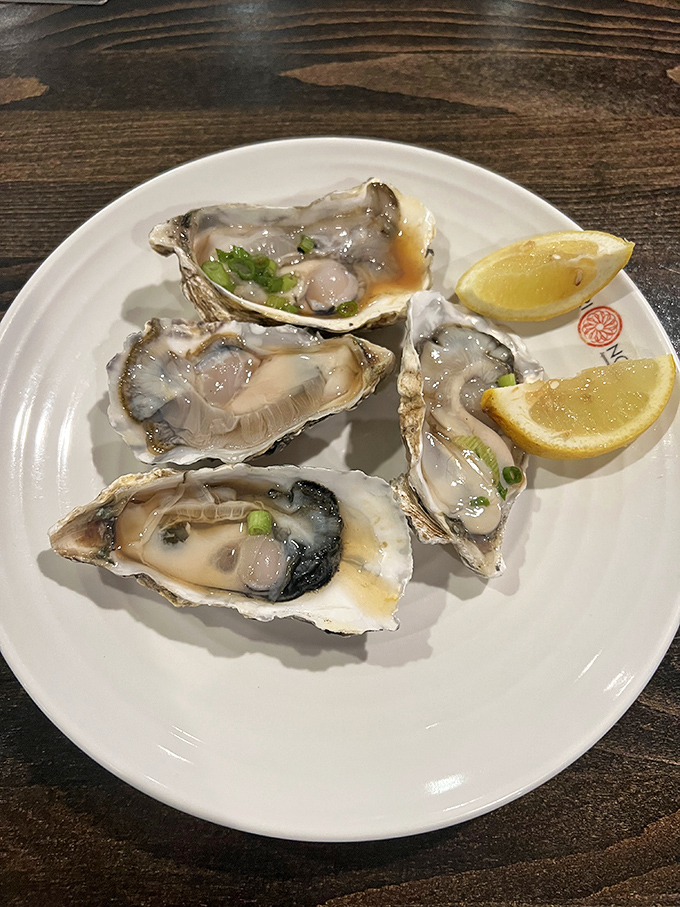Fresh oysters glistening like jewels, with lemon wedges standing by for that perfect squeeze of sunshine.
