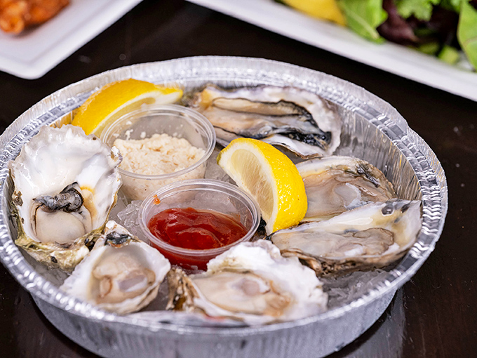 These oysters aren't just served; they're presented like jewelry on ice, with lemon wedges standing by for that perfect acidic kiss.