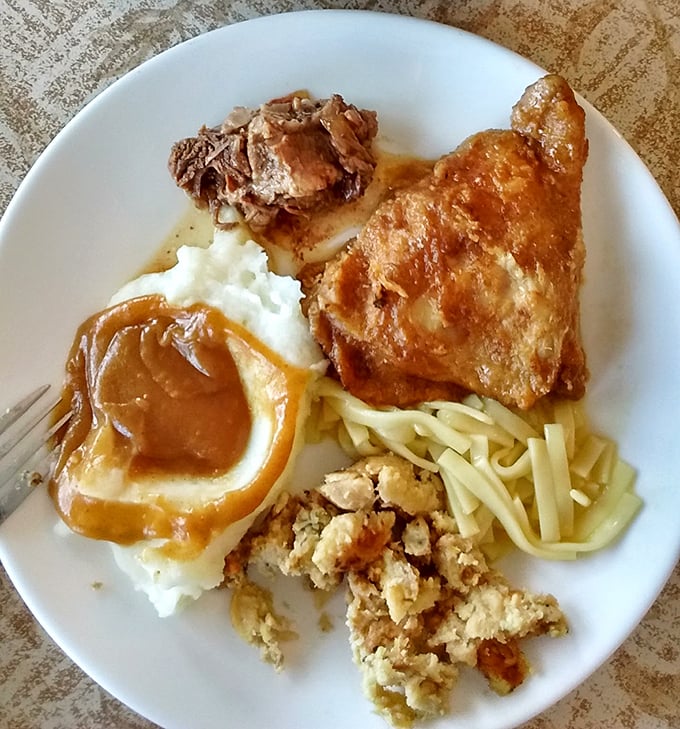 This isn't just fried chicken &ndash; it's a masterclass in comfort cuisine, resting atop a bed of noodles with gravy that could make a vegetarian question their life choices.