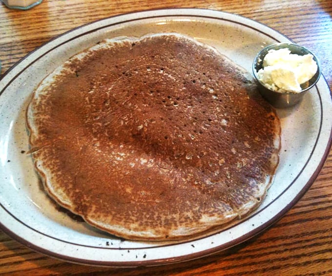 A pancake so perfectly golden it belongs in the Breakfast Hall of Fame. That little cup of butter is about to experience its finest moment.