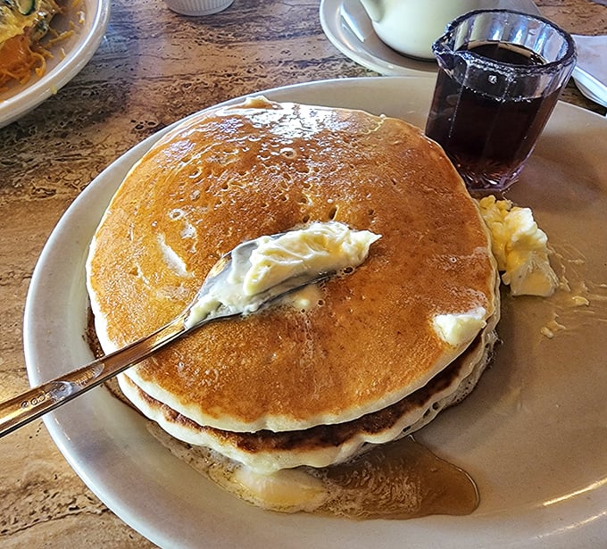Pancakes so fluffy they could float away, with butter melting into golden pockets and maple syrup standing by for the grand finale.