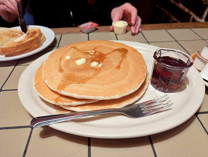 These pancakes aren't just big&mdash;they're life-affirming. Butter melting into perfect golden craters, with syrup standing by to transform your ordinary morning into something worth remembering.
