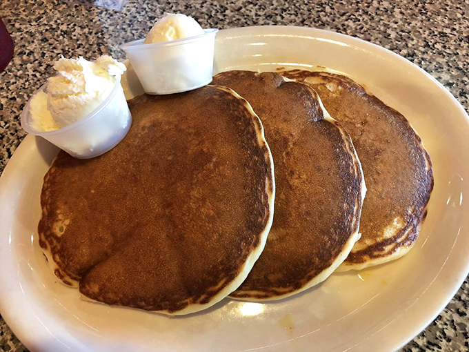 Pancake perfection that would make your grandmother jealous. Three golden discs waiting to soak up maple syrup like edible sponges.