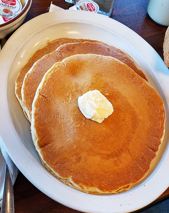 Pancakes so perfectly golden they deserve their own sunrise soundtrack. The pat of butter slowly melting is nature's most beautiful timer.