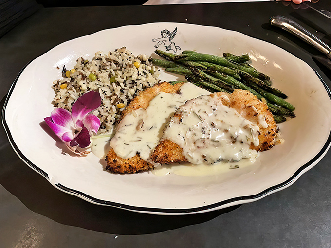 Panko-breaded chicken bathed in rosemary cream sauce with a side of wild rice and asparagus. Even the orchid looks delicious.