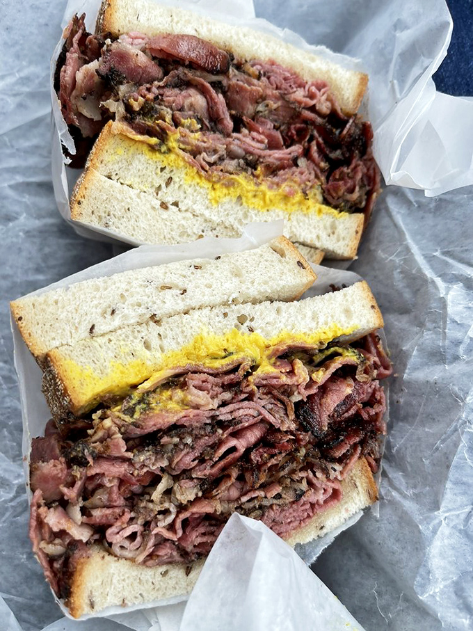 The pastrami sandwich isn't playing around &ndash; layers of pink perfection stacked higher than your weekend to-do list.